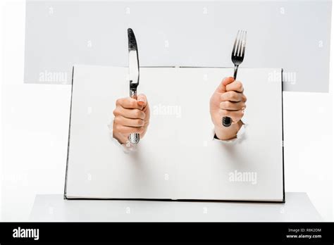 Partial View Of Woman Holding Fork And Knife Through Holes On White Stock Photo Alamy