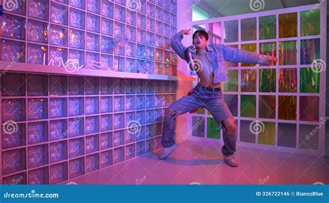 Asian Performer Moving Freestyle Dance While Looking At Camera