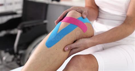 Woman Holding Her Sore Knee With Hand With Kinesio Tapes 4k Movie Slow