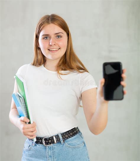Young Girl Student Showing Modern Smart Phone With Blank Screen Stock