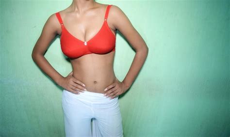 Premium Photo Midsection Of Woman With Hands On Hip Standing Against Wall