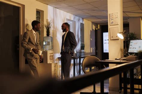 Corporate Employees Discussing Project Detalies During Work Break Stock