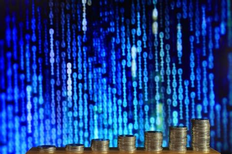 Premium Photo Stacked Coins Against Binary Code On Screen
