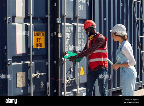 Businesswoman And Engineer Talking And Checking Loading Containers Box From Cargo Freight Ship
