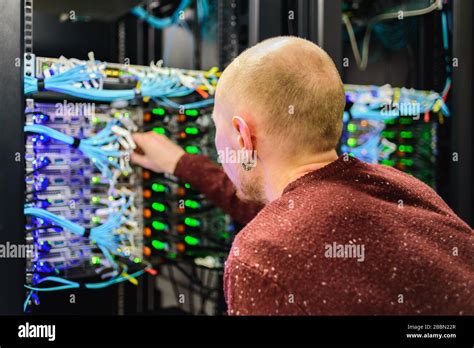 Man Data Center Technician Performing Server Maintenance Replacing