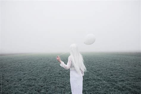 Back View Of A Young Woman Holding A Balloon By Stocksy Contributor