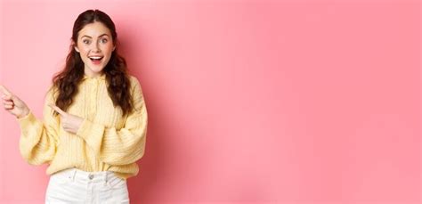 Free Photo Young Excited Woman In Casual Outfit Showing Banner