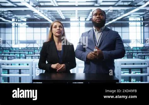 Admin And Coworker Looking At Holograms In Data Center Doing Swiping