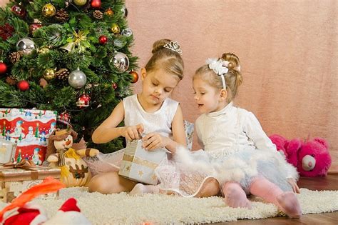 Five Year And Three Year Girl In A New Year Dress Sitting On A Mat At