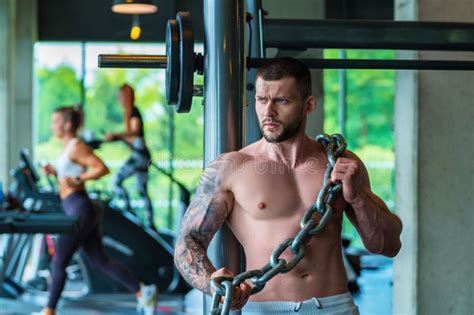 Muscular Hunk With Posing In Gym Fitness Male Model Near Gym Equipment
