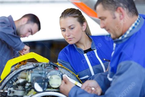 Group Of People During Engine Assembling Photo Background And Picture Group Of People During Engine Assembling Photo Background And Picture