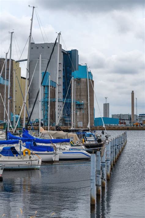 Small Sailing Boats In Halmstad Port With Industrial Buildings In