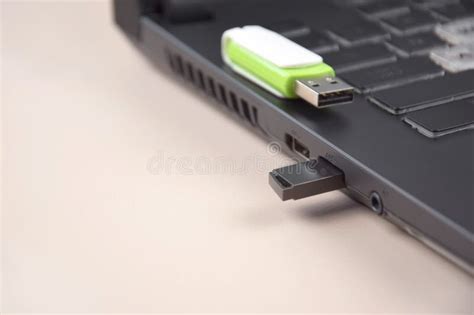 usb memory stick or flash drive on the keyboard of an open laptop