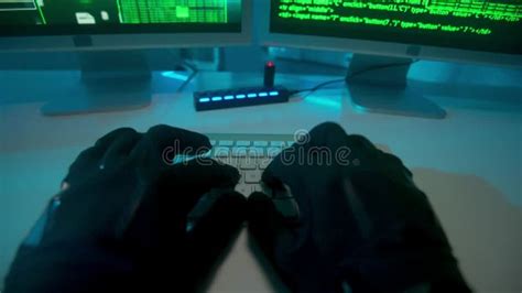 Hacker Stretching Hands In Black Gloves And Typing On A Computer