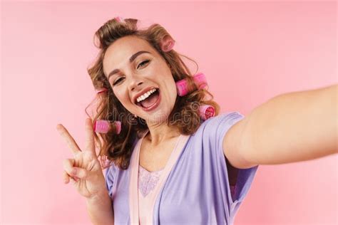 Image Of Smiling Woman Gesturing Peace Sign While Taking Selfie Stock