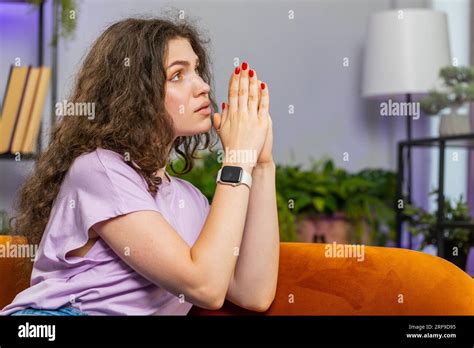 Please God Help Young Woman Praying Sincerely With Folded Arms