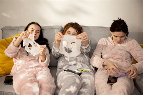 Happy Female Friends Having Good Time At Pajama Party In The Bedroom