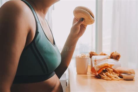 Binge Eating Disorder Concept With Woman Eating Fast Food Burger Fired