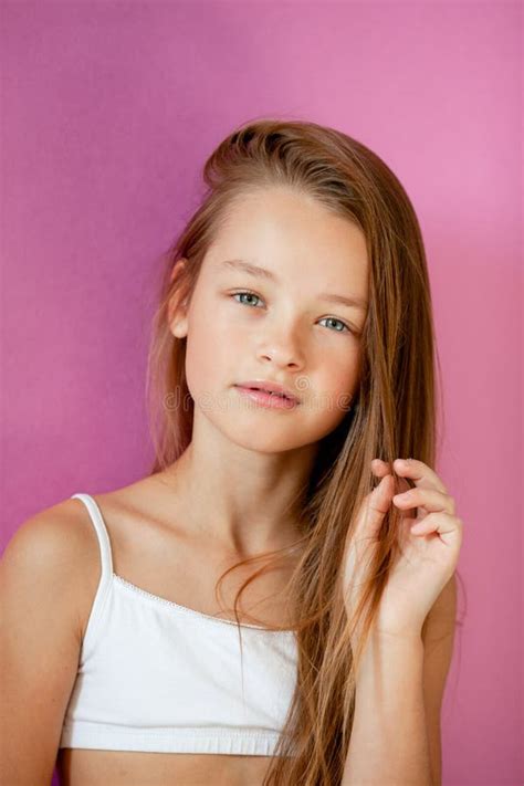 Portrait Of A Gentle 9 Year Old Long Haired Girl In A Light T Shirt
