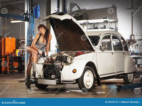 A Woman Repairing A Retro Car In A Garage Stock Image Image Of Garage