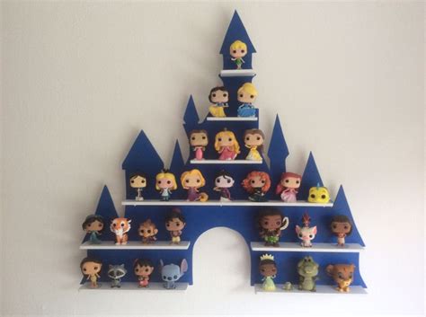 There Are Many Disney Princess Figurines On The Shelves In Front Of The