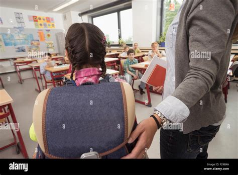 Female Teacher Introducing A New Classmate In Classroom Munich Stock Photo Alamy