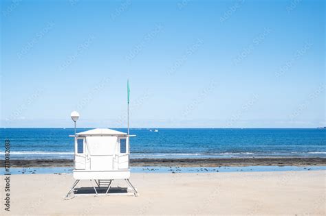 white lifeguard tower on a deserted beach the clear sky and calm sea