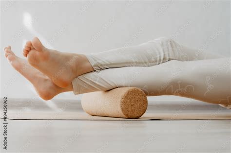 Close Up Of Person Doing Calf Muscles Myofascial Release On A Cork