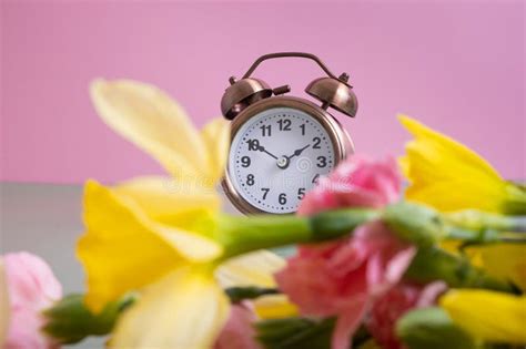 Alarm Clock With Spring Flowers Spring Time Daylight Savings Concept