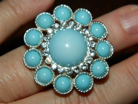 blue flower shaped expandable ring a blue floral ring w small white