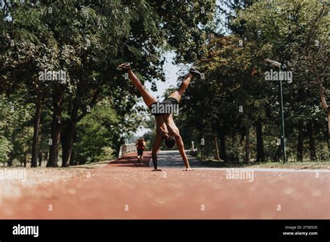 fit elastic male person practicing cardio and flexibility in the park
