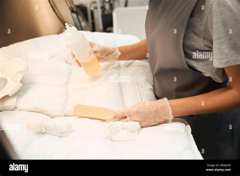 Dry Cleaning Operator Identifying Stains And Applying Removal Agent