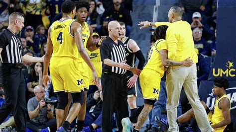 Juwan Howard Restrained By Michigan Player On Court