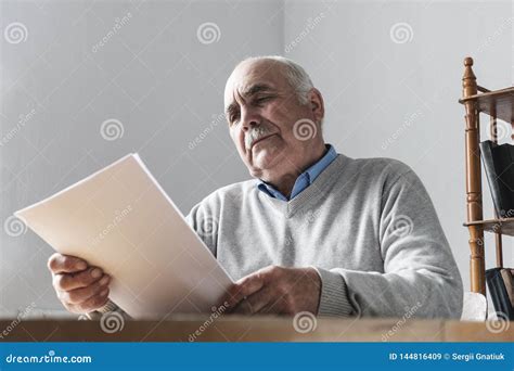 Senior Man Reading A Paper Document Or Letter Stock Image Image Of