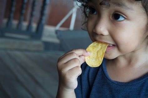 Premium Photo Close Up Of Girl Eating Snack