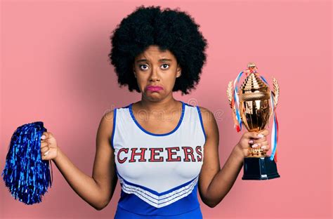Young African American Woman Wearing Cheerleader Uniform Holding Pompom