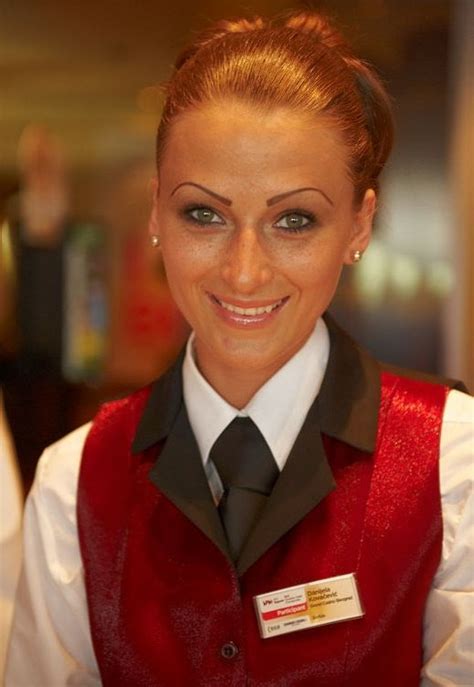 Waitresses Dressed In Formal Work Uniform With White Shirt And Black
