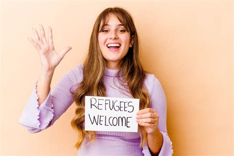 Premium Photo Young Caucasian Woman Holding A Refugees Welcome