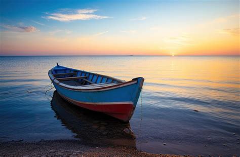 Premium Ai Image Boat Floats On The Calm Waters Landscape Sunset On