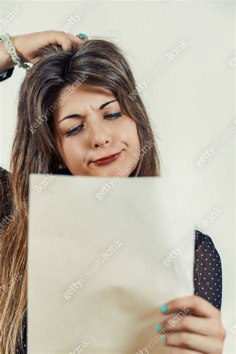 Young Woman Having Doubts While Reading A Document 이미지 2180981040
