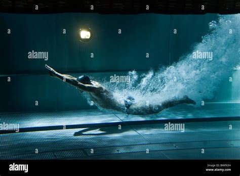 Professional Swimmer Underwater After The Jump In Swimming Pool Stock
