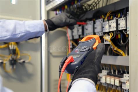 Electrical Engineer Using Digital Multi Meter Measuring Equipment To Checking Electric Current