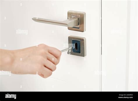 Woman Open Door Lock With A Key Close Up Of Door Key In Keyhole Stock Photo Alamy