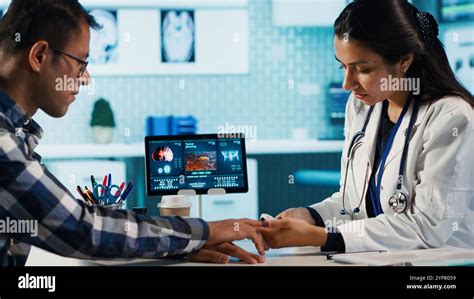 Healthcare Professional Uses Oximeter To Measure Oxygen Levels For Patient At Check Up