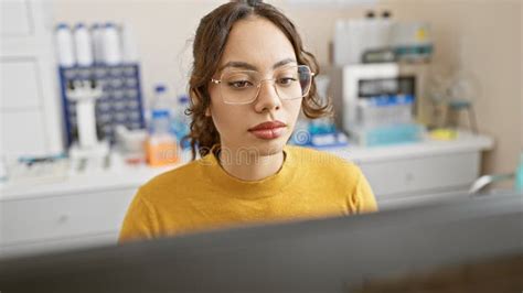 Focused Woman Wearing Glasses Analyzing Data In A Modern Laboratory Setting Stock Image Image
