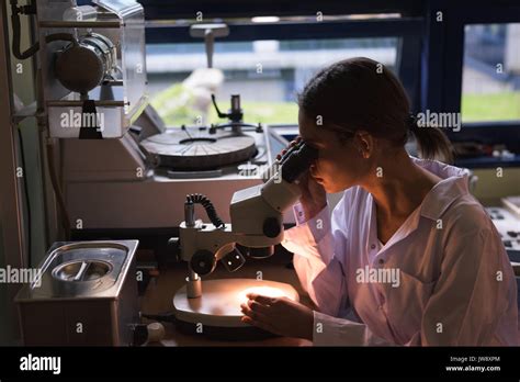 Female College Babe Using Microscope While Practicing Experiment In Lab Stock Photo Alamy