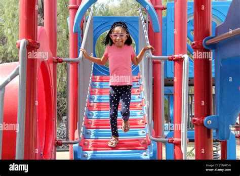 5 Year Old Latina Brunette Girl With Glasses Plays In The Park Games As