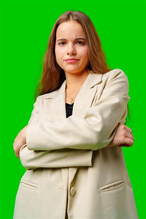 Young Woman Posing In Beige Suit Against Green Background Stock Image