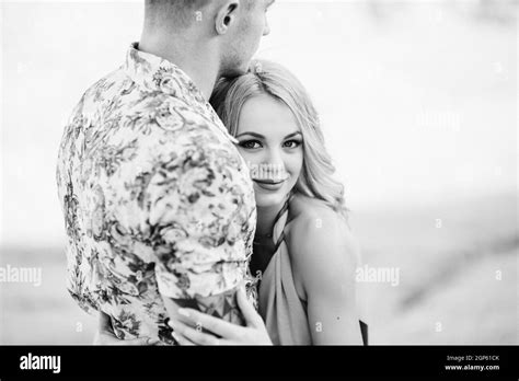 Blonde Girl In A Light Blue Dress And A Guy In A Light Shirt And Short