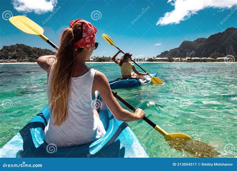 Two Girls Walks By Sea Kayaks Or Canoes Stock Image Image Of Outdoor